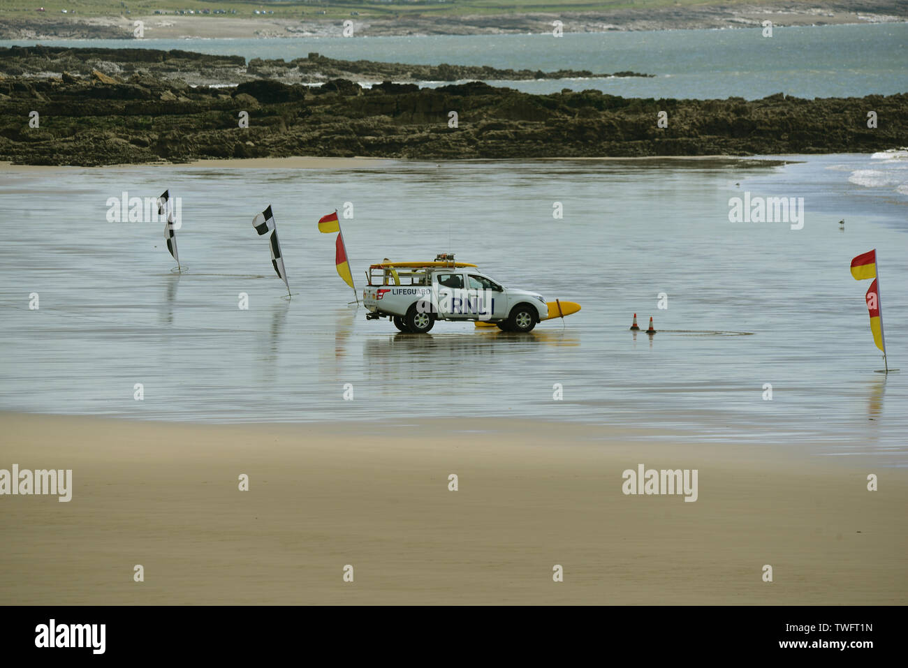 RNLI Lifeguard vehicle pictured on a deserted Coney Beach, Porthcawl ...