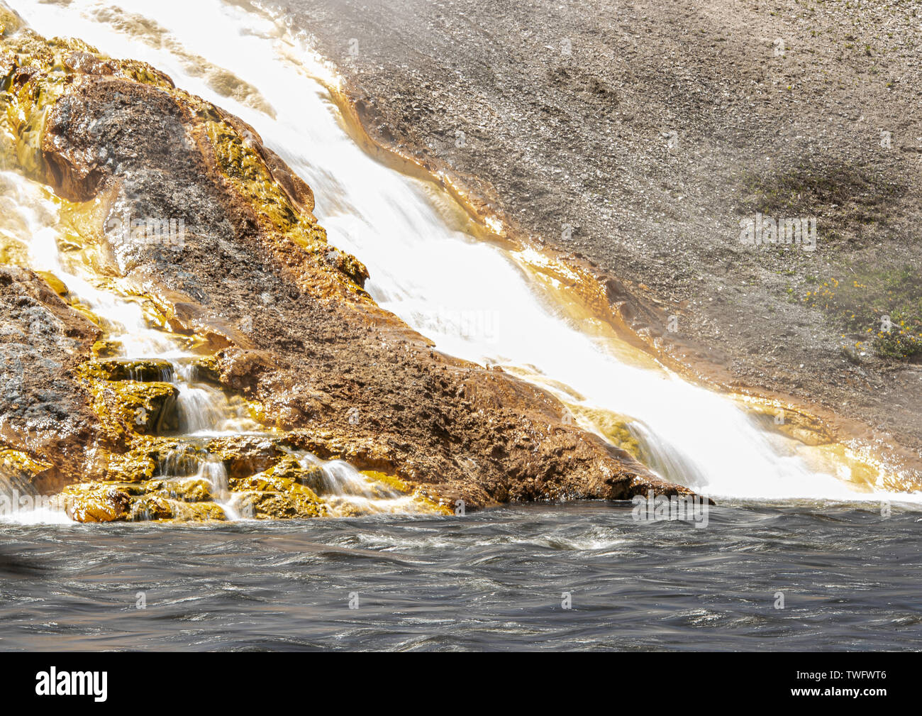Water running off Excelsior geyser crater into the Firehole river Stock ...