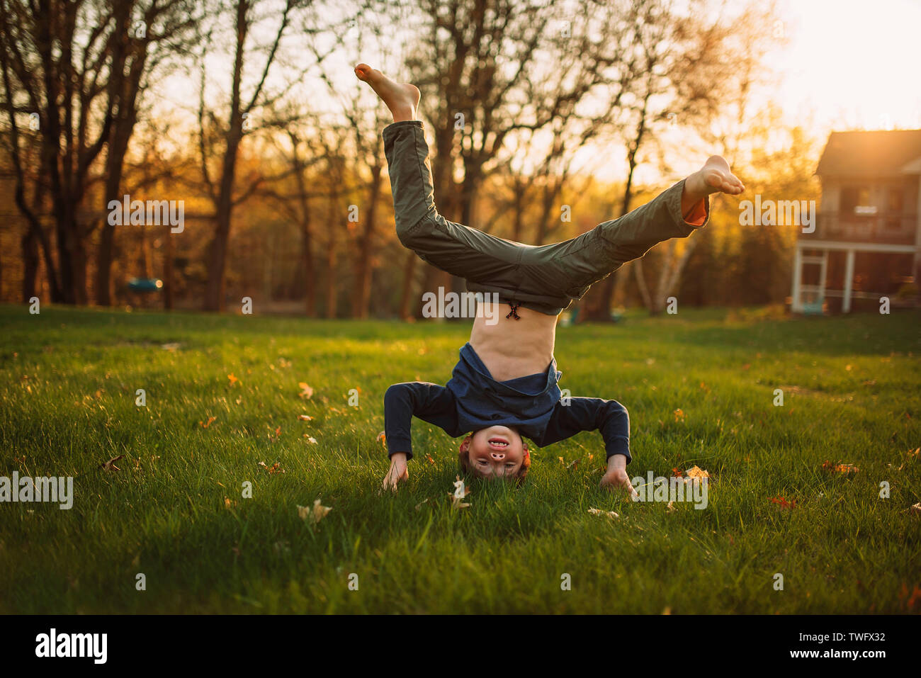 Boy doing a handstand in the garden, United States Stock Photo - Alamy