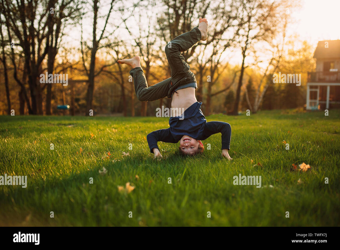 Child doing handstand hi-res stock photography and images - Alamy