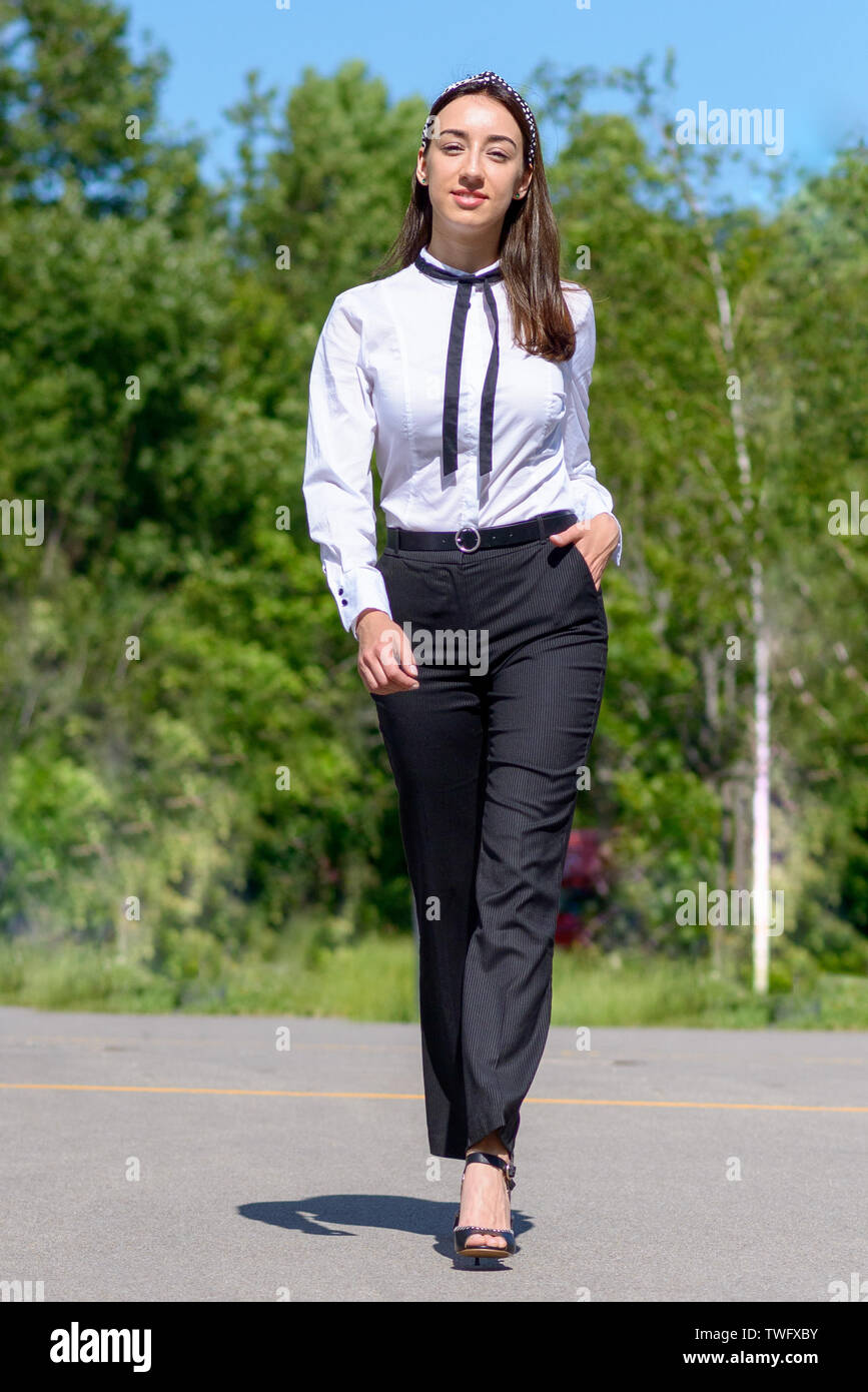 Young woman confidently walking up hi-res stock photography and images ...