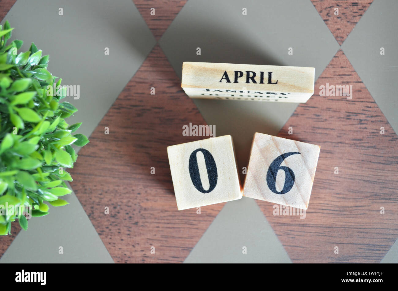 Date of April with leaf on diamond pattern table for background Stock ...