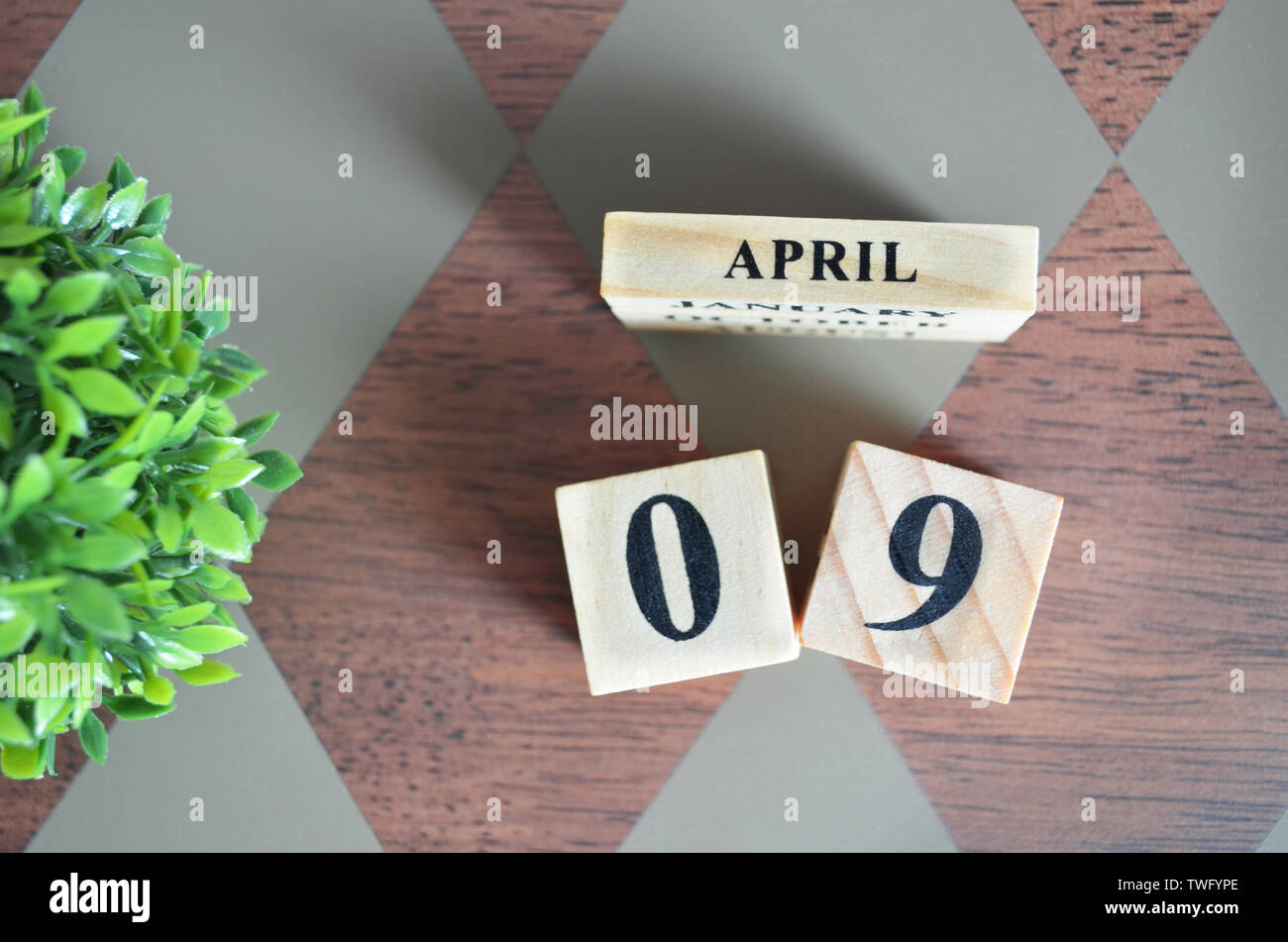 Date of April with leaf on diamond pattern table for background Stock ...