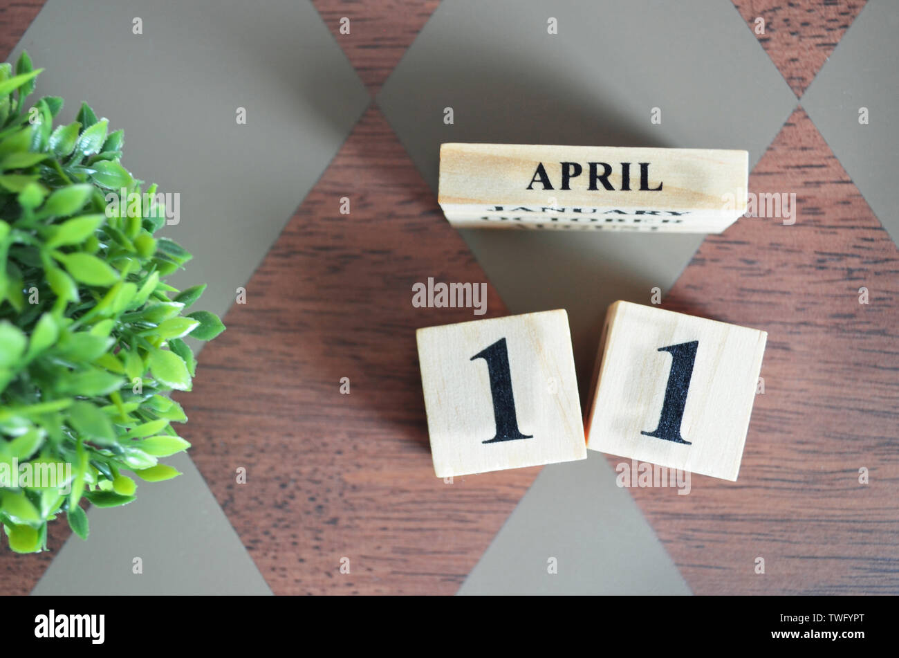 Date of April with leaf on diamond pattern table for background Stock ...