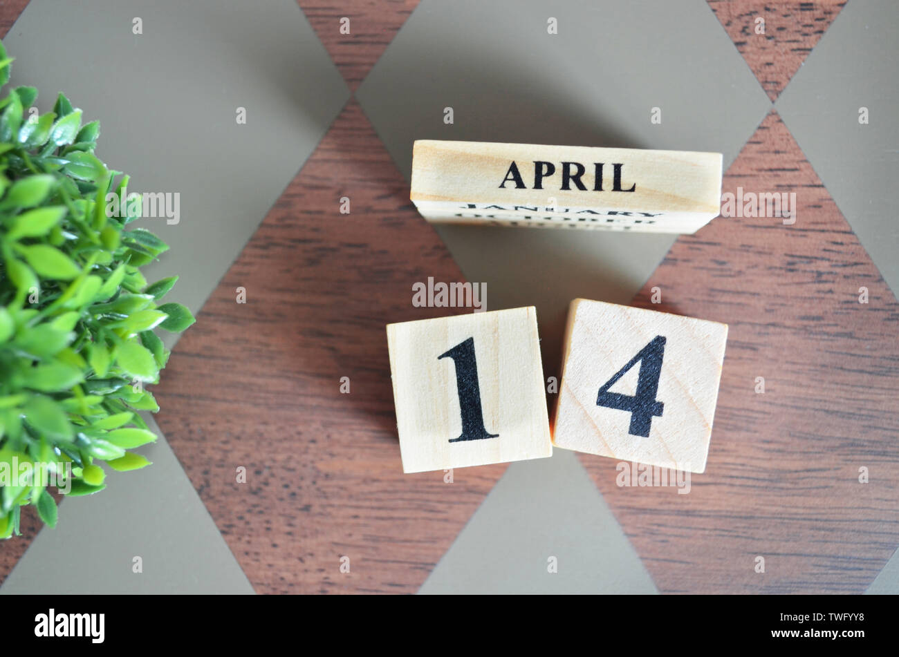 Date of April with leaf on diamond pattern table for background Stock ...