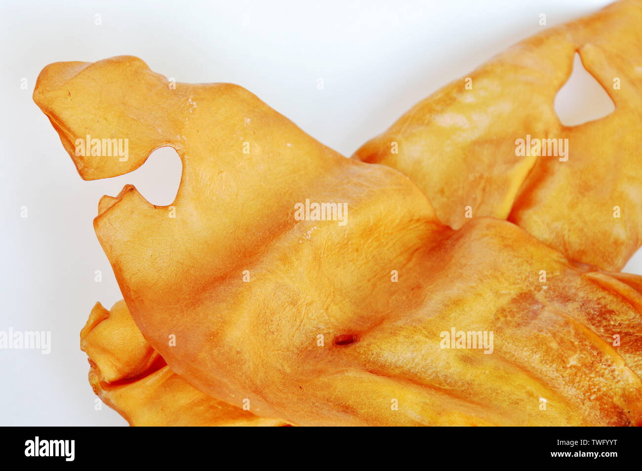 dried cow ear on white background Stock Photo - Alamy