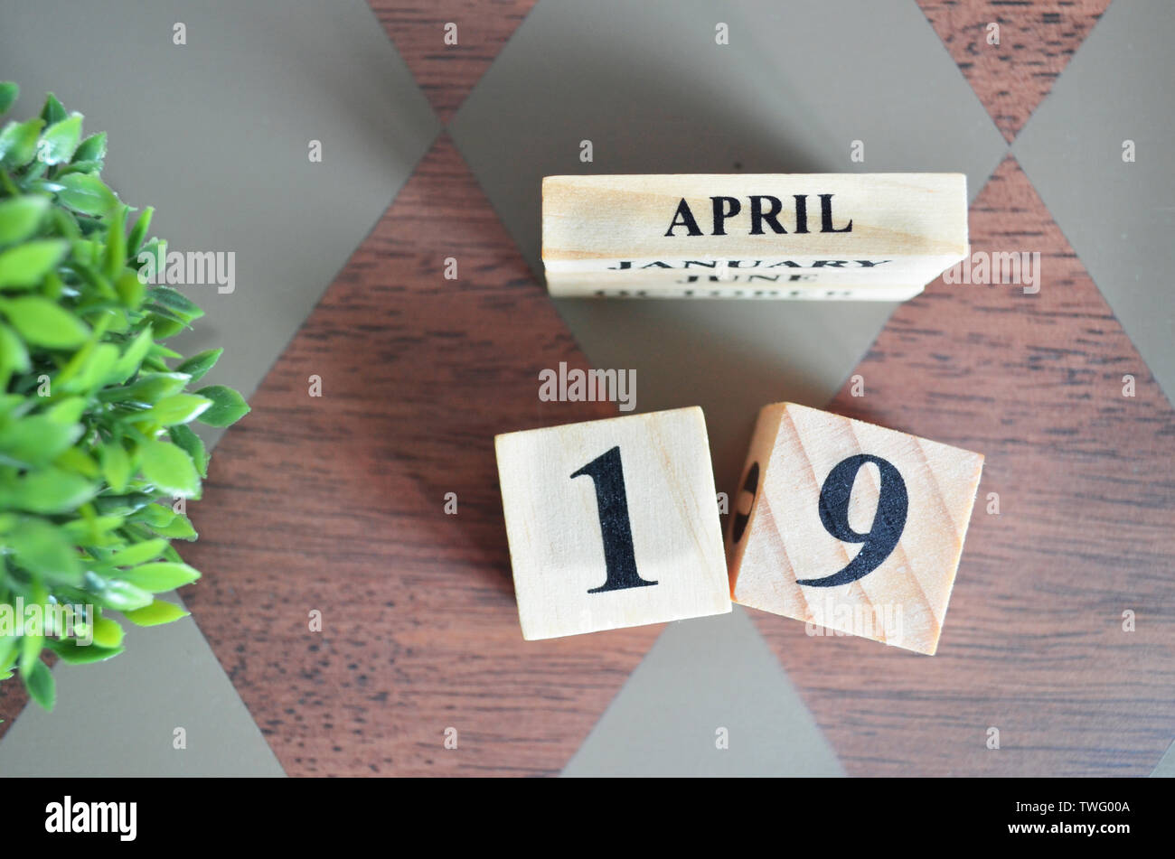Date of April with leaf on diamond pattern table for background Stock ...