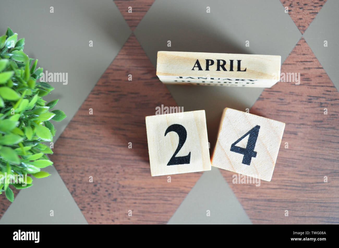 Date of April with leaf on diamond pattern table for background Stock ...