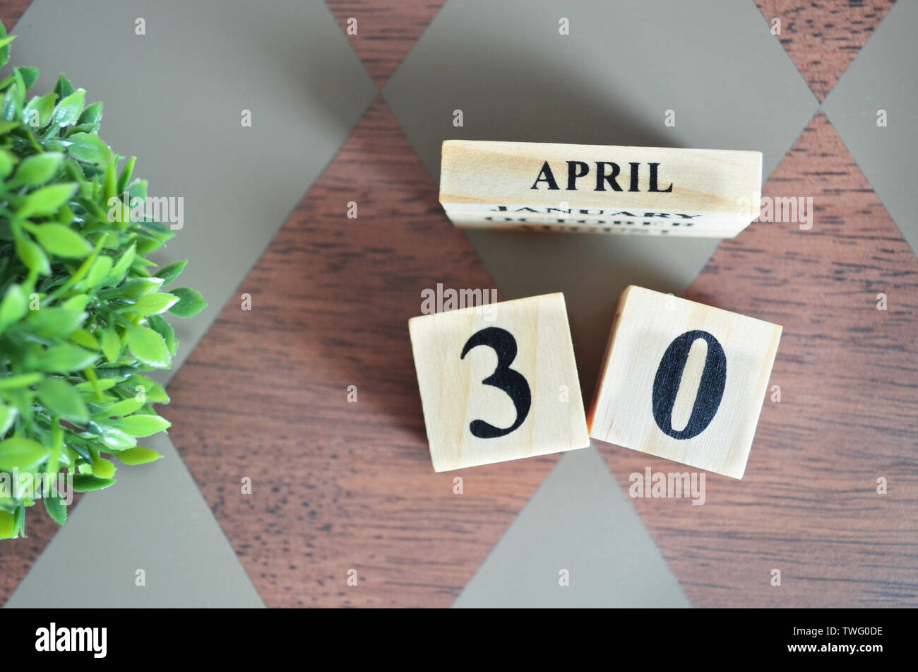 Date of April with leaf on diamond pattern table for background Stock ...