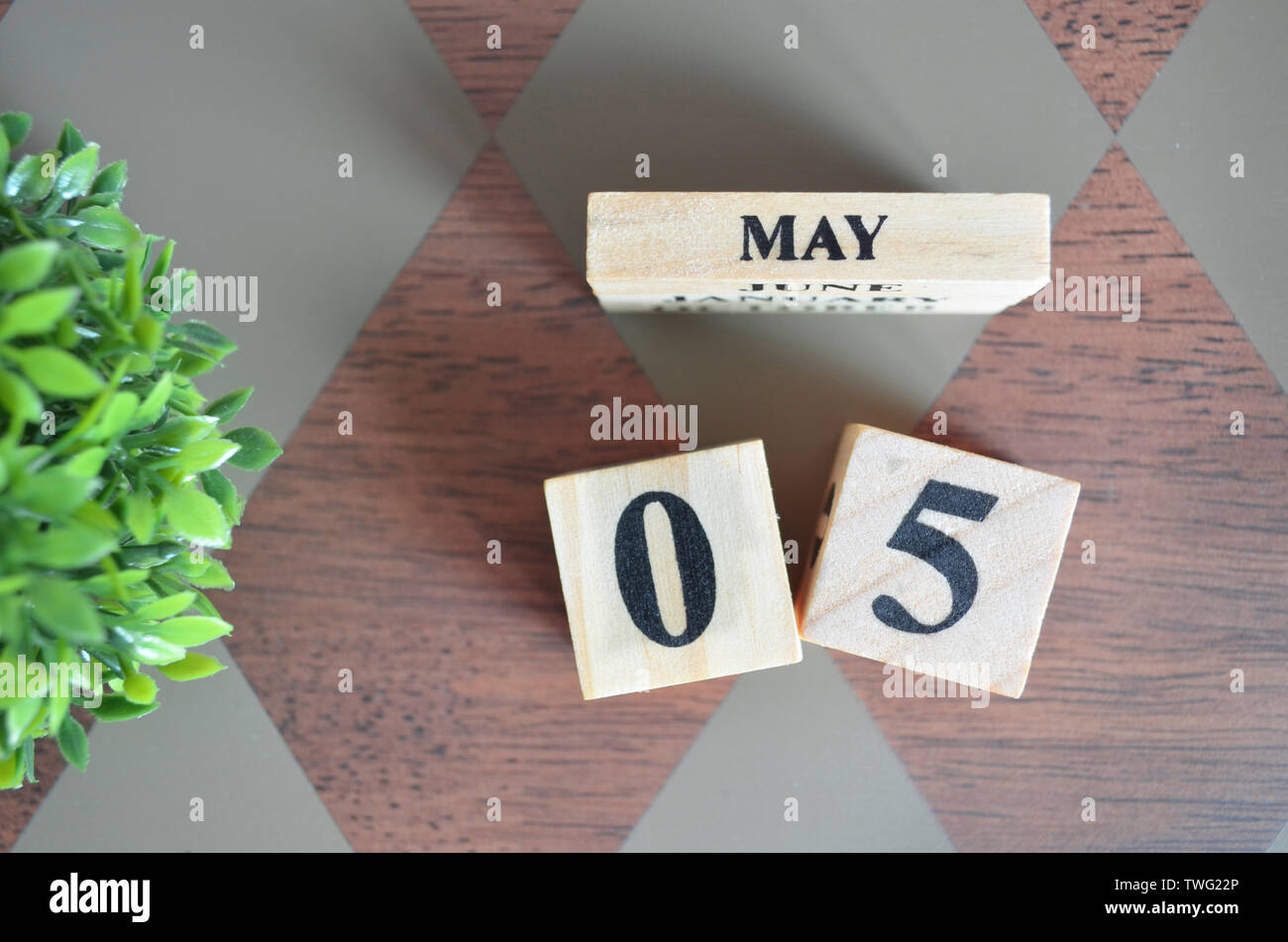 Date of May with leaf on diamond pattern table for background Stock ...