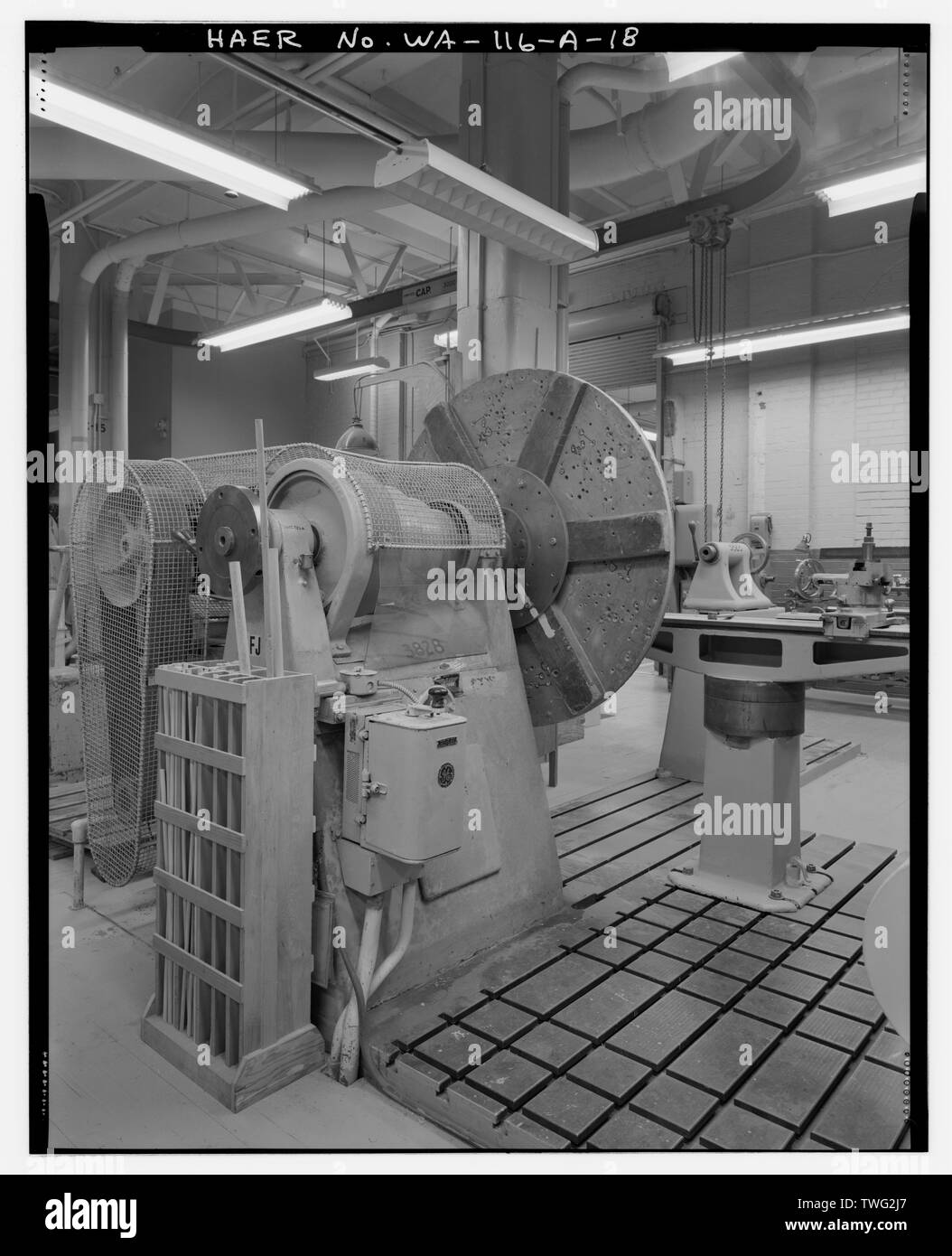 Post Lathe. View of wheel, motor, belt, casing and grooved steel base ...
