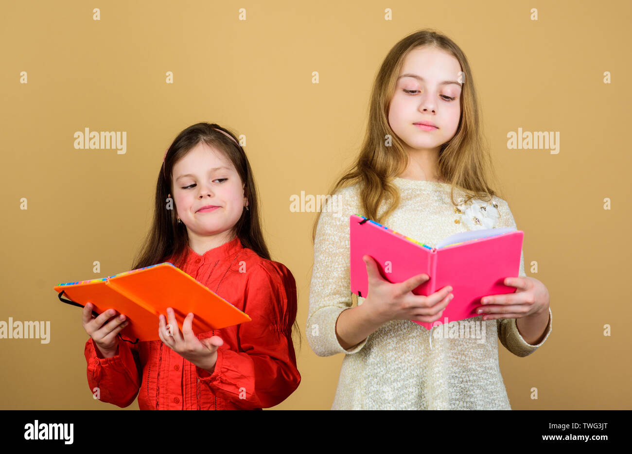 Sisters pick books to read together. Adorable girls love books. Secret ...