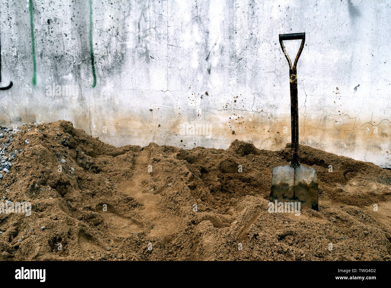 The shovels that are placed on the sand pile are used to scoop the sand ...