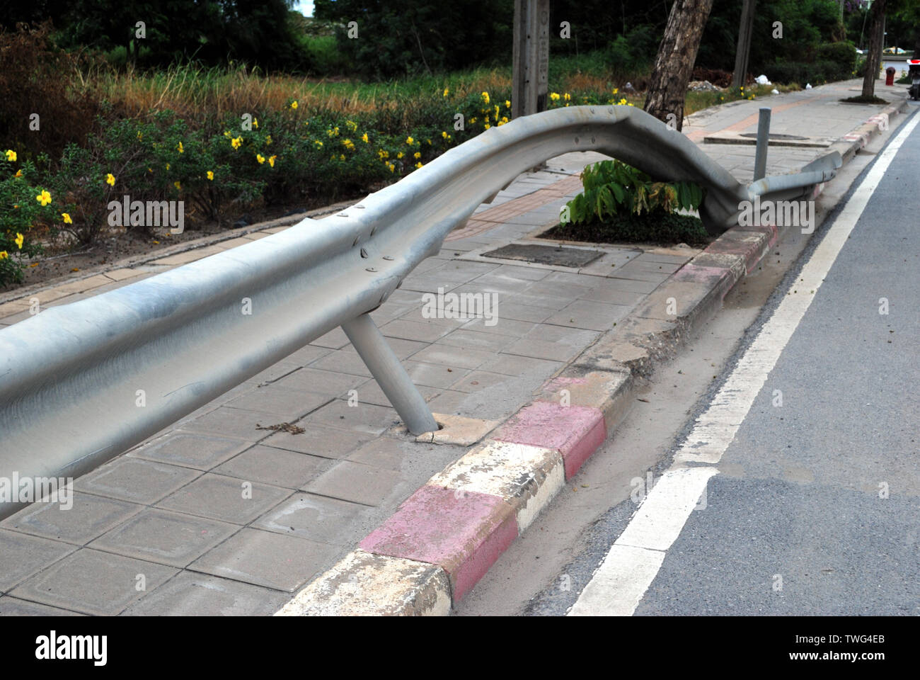 The fence on the side of the road in the curve of the road is distorted ...