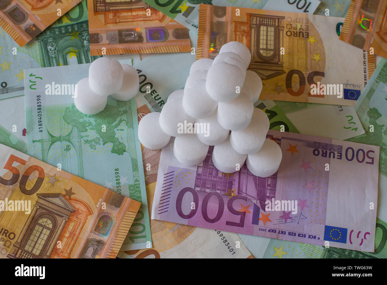 Salt pellets on the background of Euro banknotes Stock Photo - Alamy