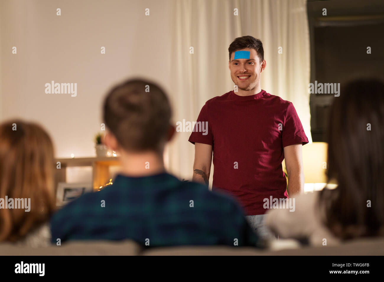 friends playing guessing game at home in evening Stock Photo - Alamy
