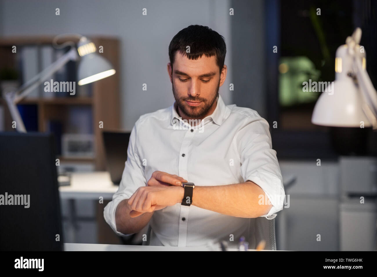happy businessman with smart watch at nigh office Stock Photo - Alamy