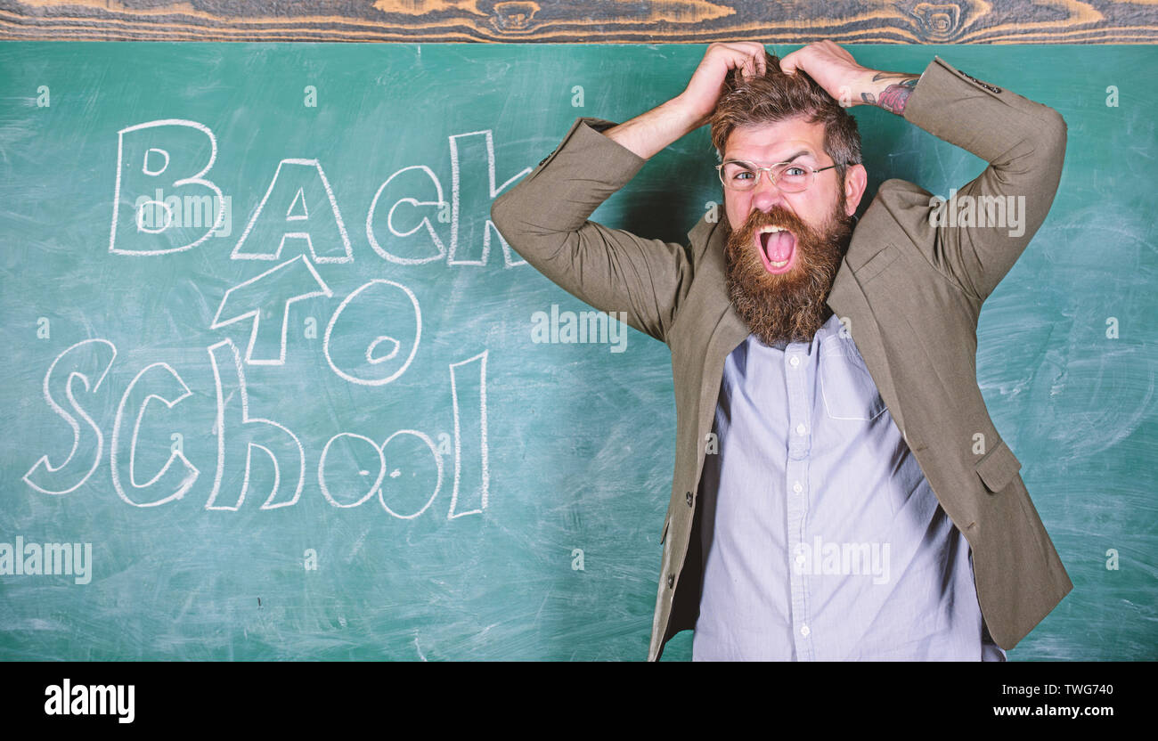 Hate school. Teacher or educator stands near chalkboard with ...