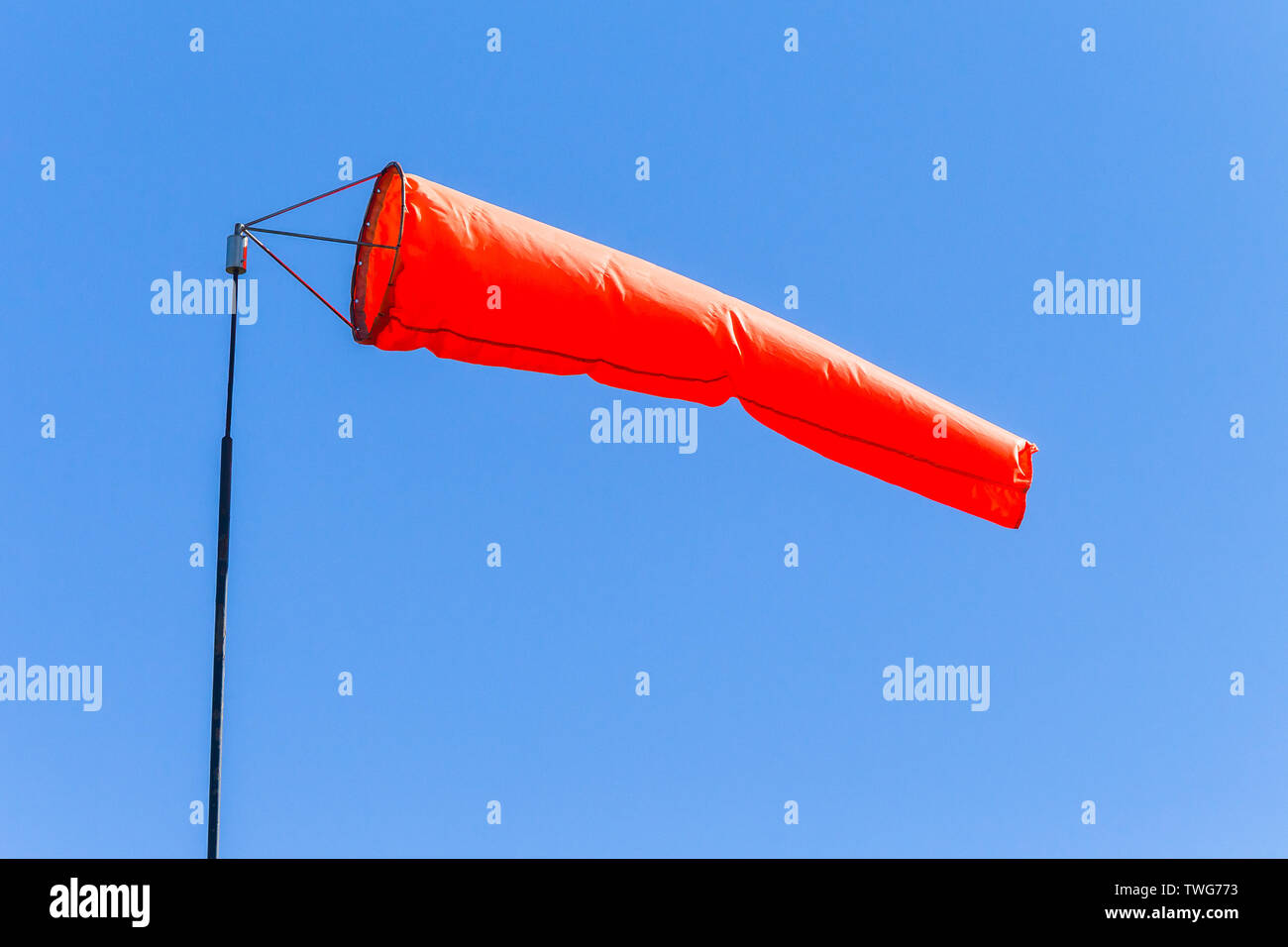 Weather wind sock bright color against blue sky for flying aircraft ...