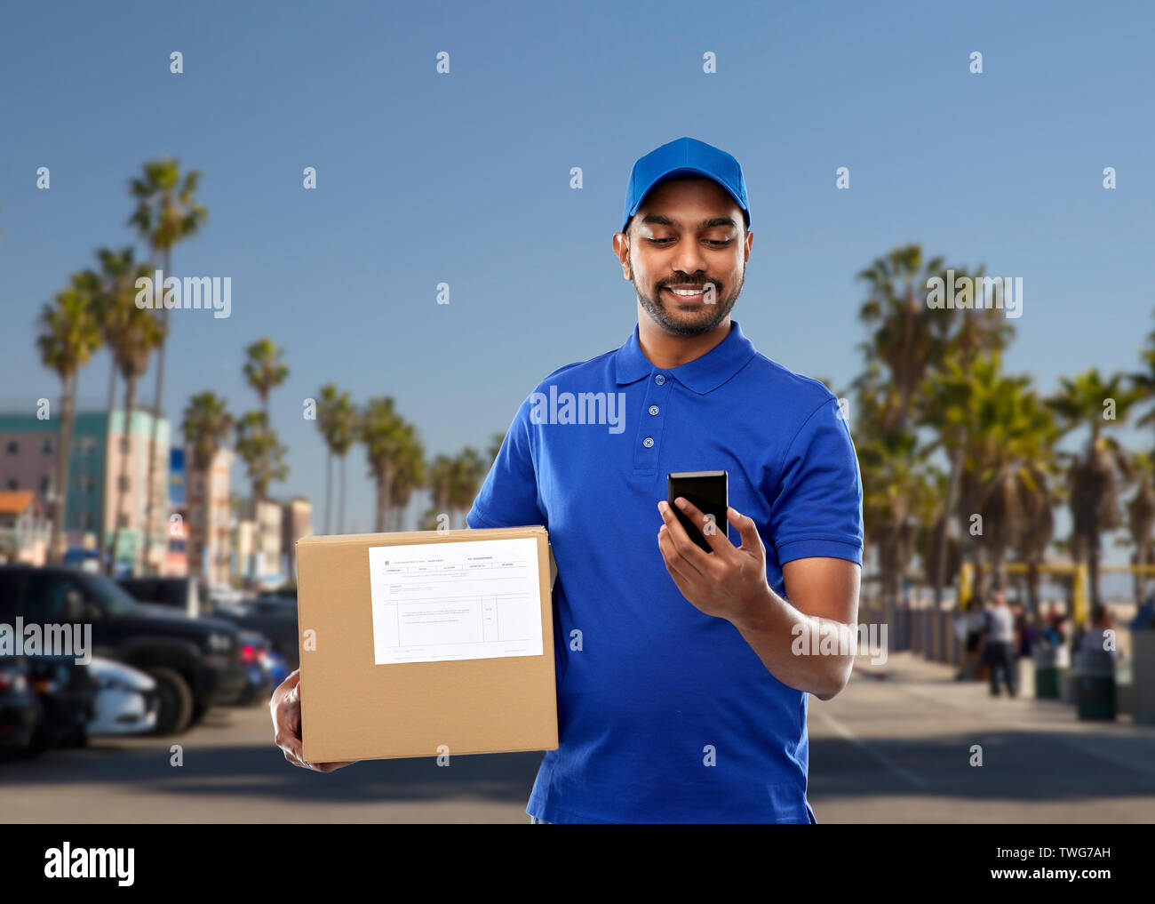 indian delivery man with smartphone and parcel box Stock Photo - Alamy