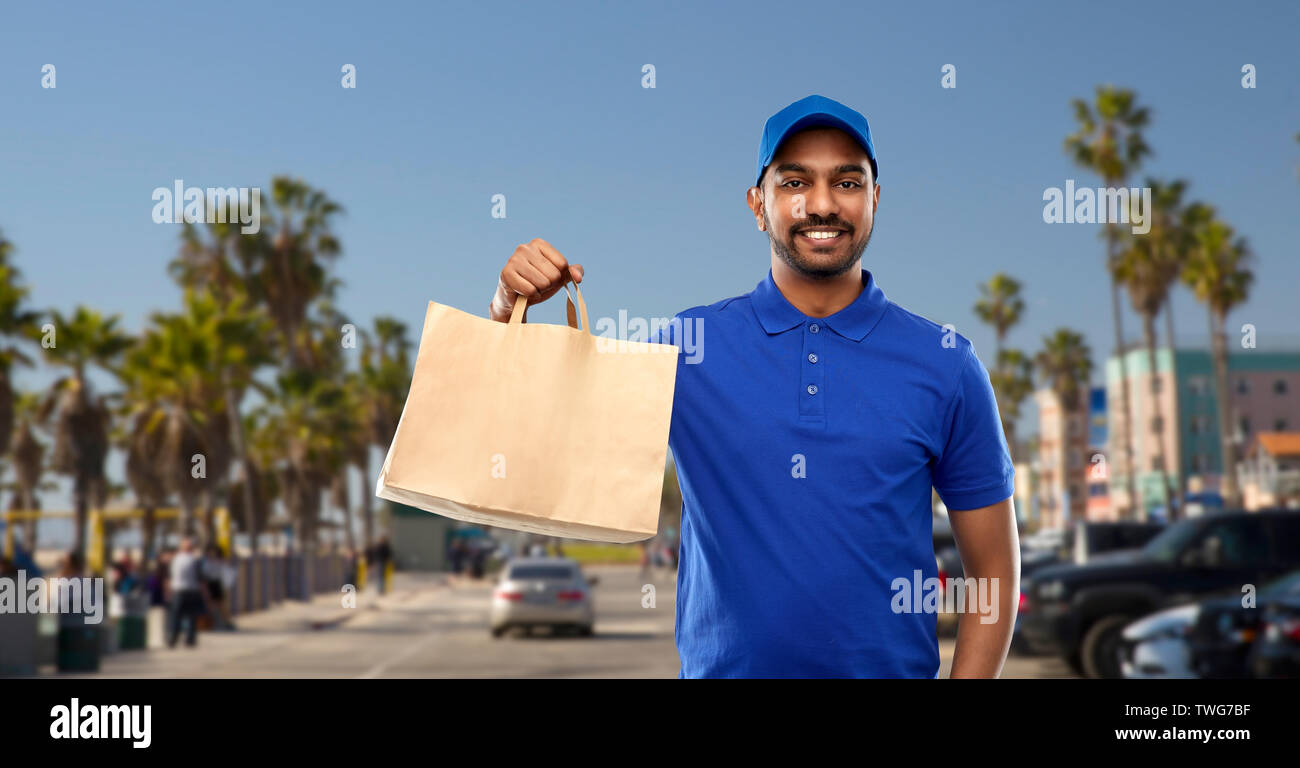 happy indian delivery man with food in paper bag Stock Photo - Alamy