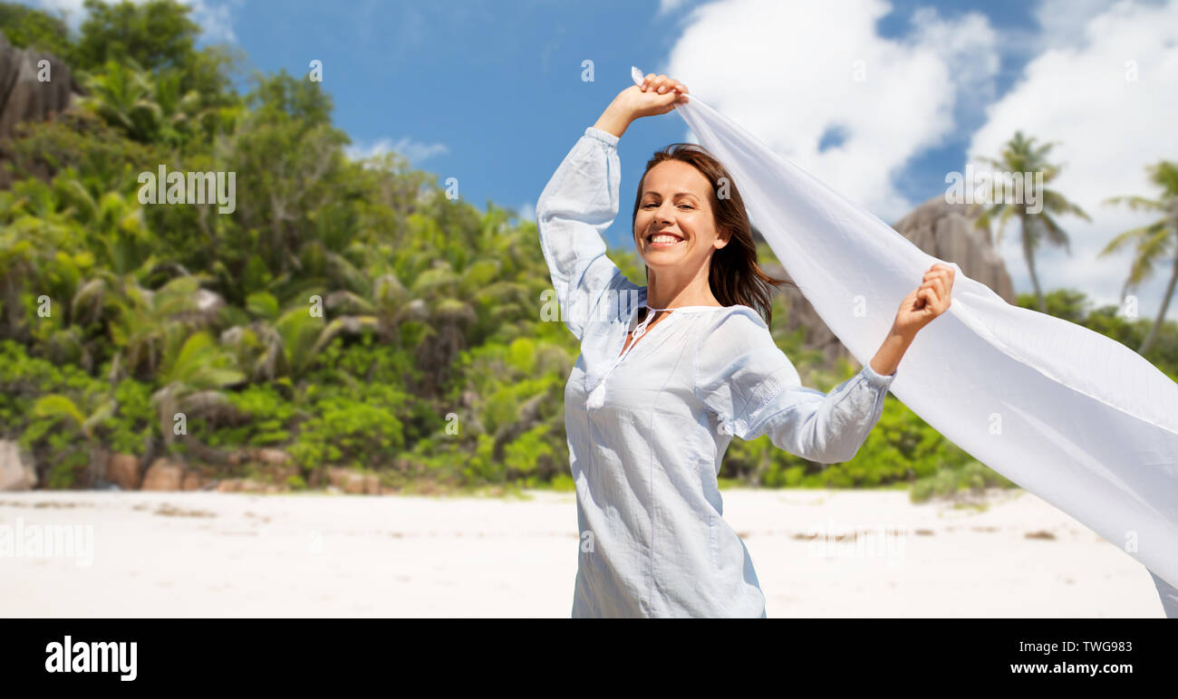 happy woman with shawl waving in wind on beach Stock Photo - Alamy