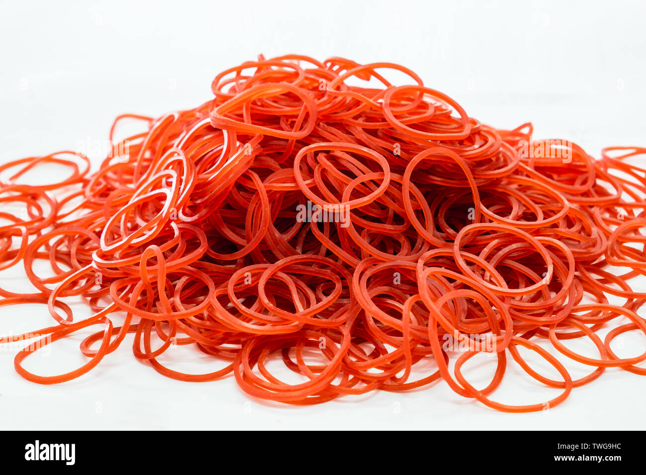 Red plastic band circle cluster on white background Stock Photo - Alamy