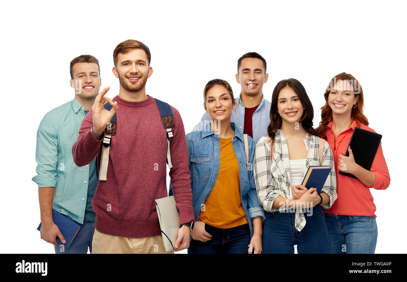 group of smiling students showing ok hand sign Stock Photo - Alamy