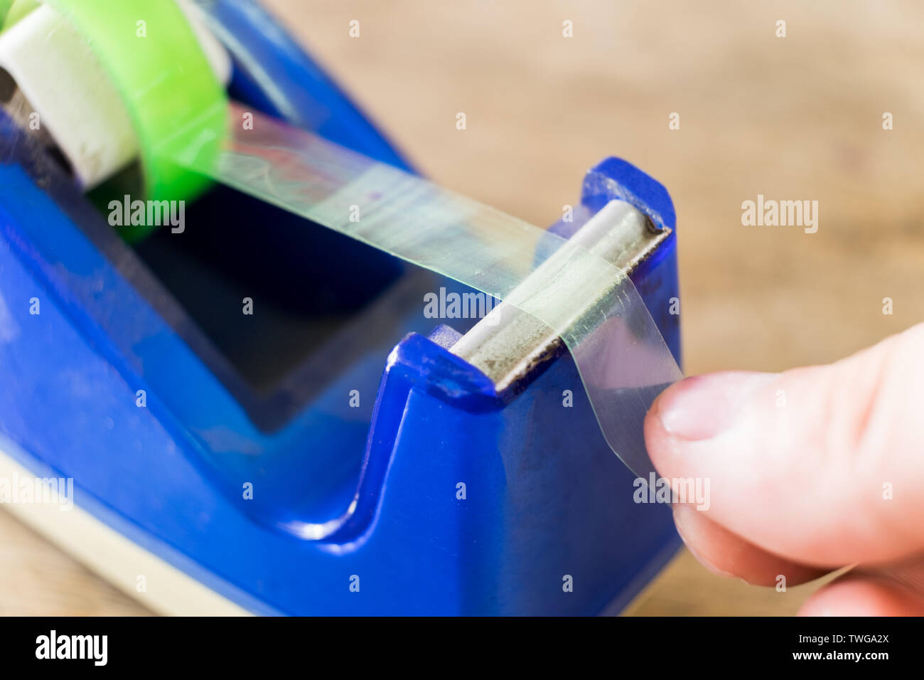 Hand pulling roll duct tape hi-res stock photography and images - Alamy
