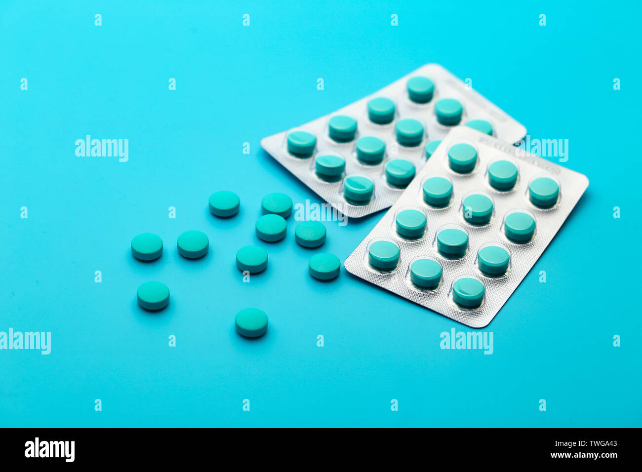 blue tablets on blue background Stock Photo - Alamy