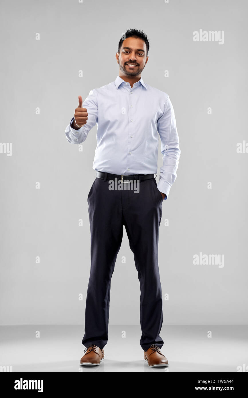 smiling indian businessman showing thumbs up Stock Photo - Alamy