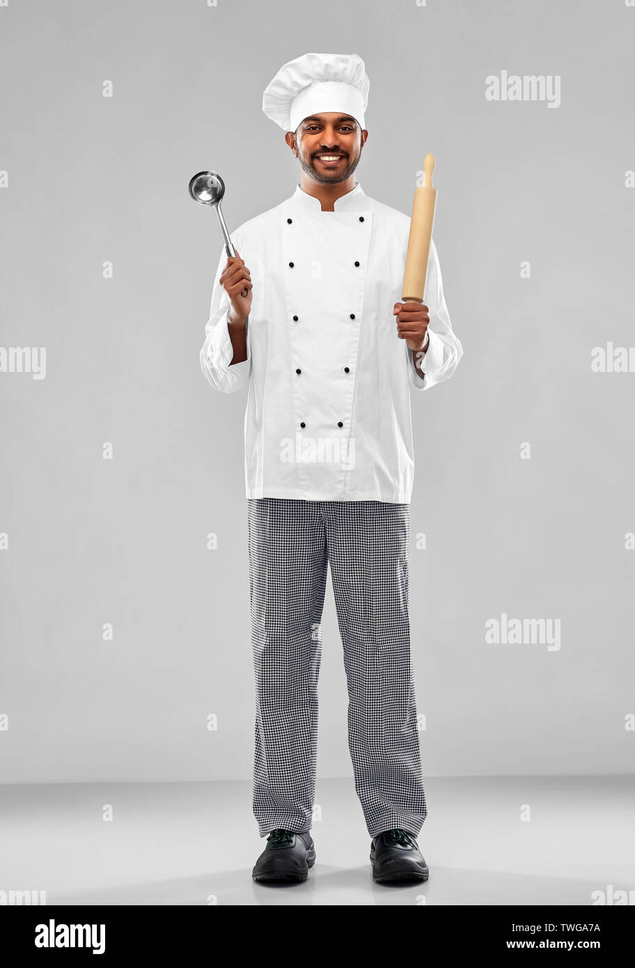 happy indian chef with ladle and rolling-pin Stock Photo - Alamy