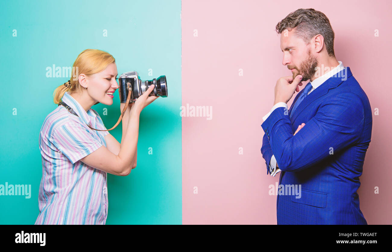 Capturing the confidence. Businessman posing in front of female ...