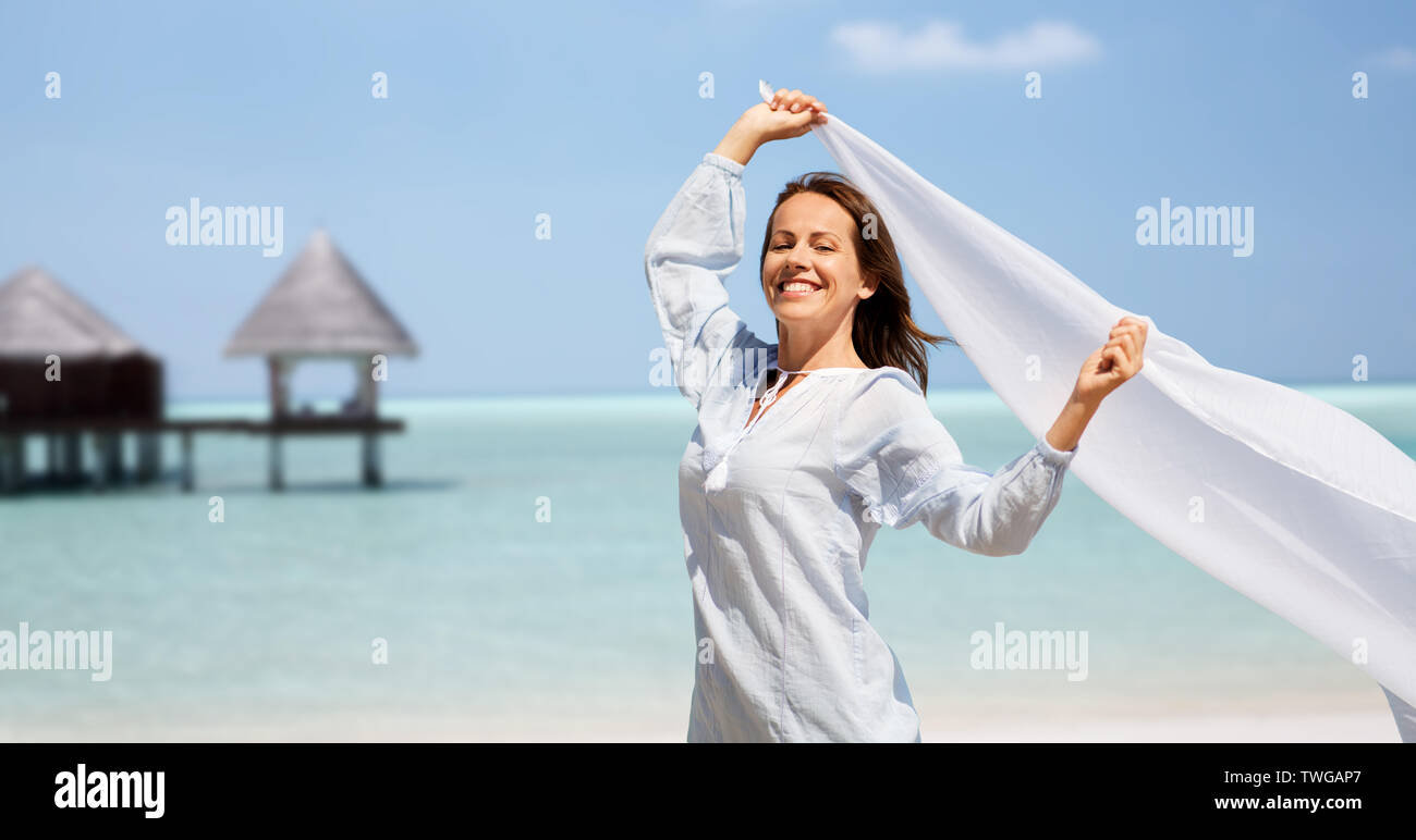 happy woman with shawl waving in wind on beach Stock Photo - Alamy