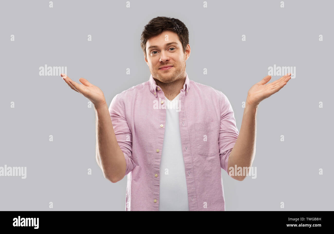 Young man shrugging hi-res stock photography and images - Alamy