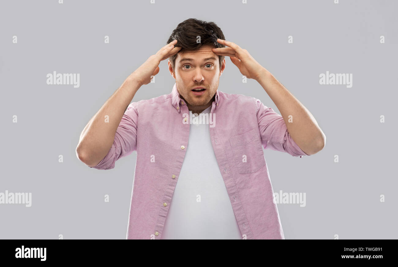 man touching his head Stock Photo - Alamy