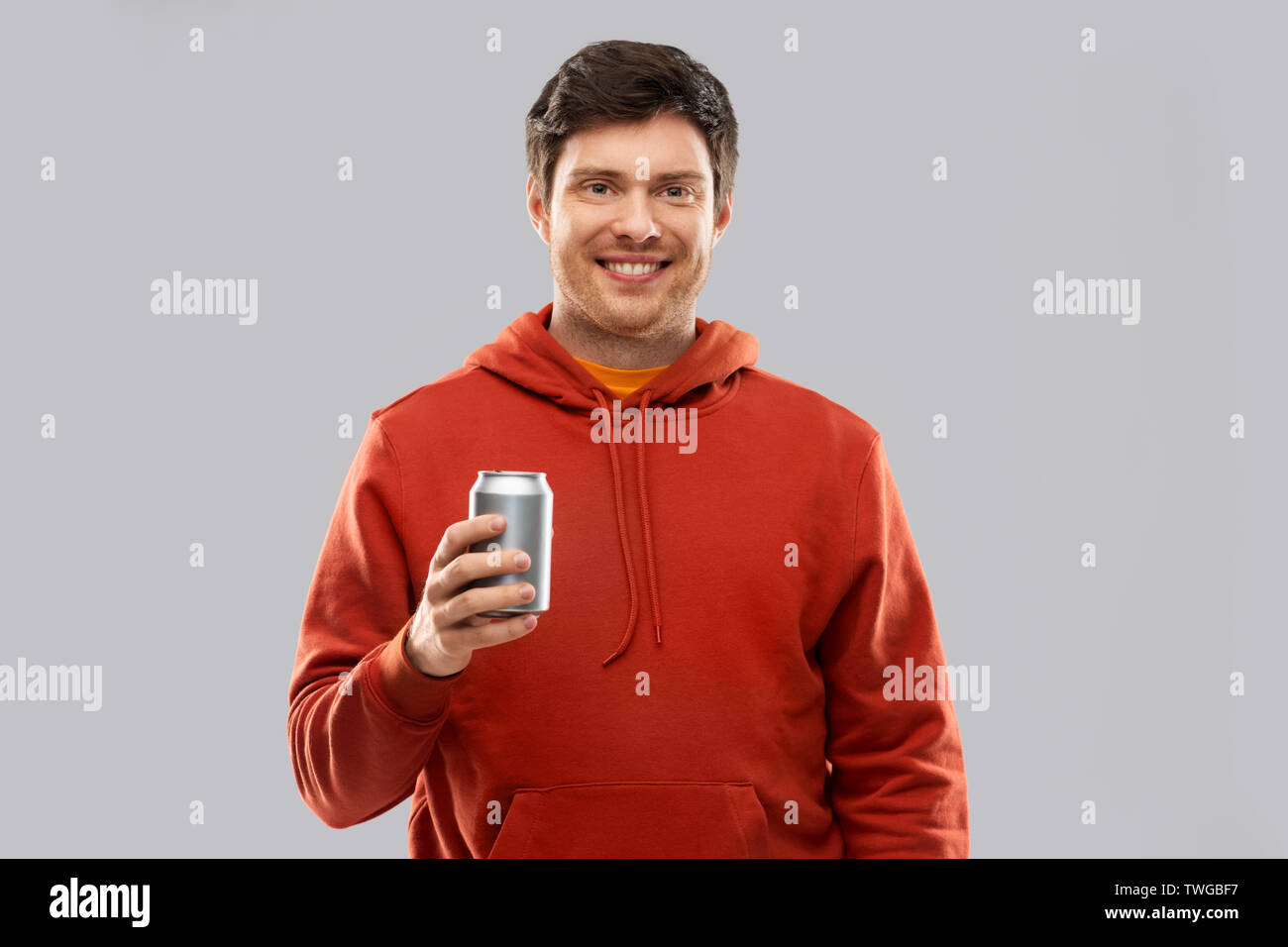 happy young man drinking soda from tin can Stock Photo - Alamy