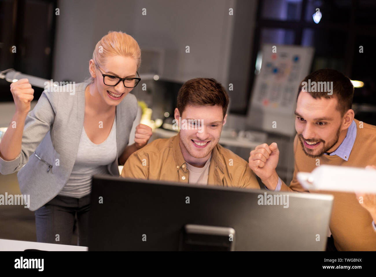 business team celebrating success at night office Stock Photo - Alamy