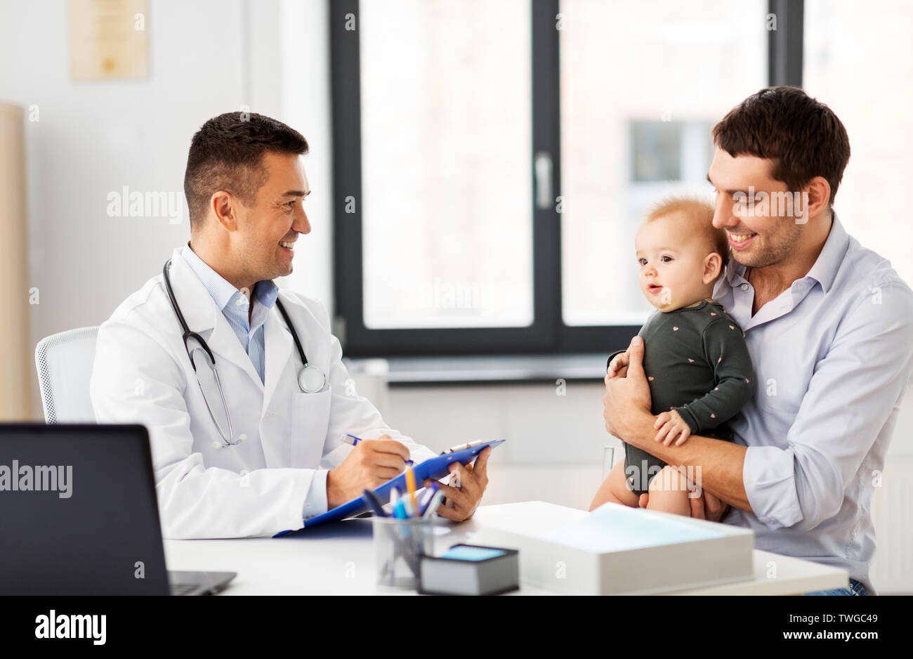 father with baby and doctor at clinic Stock Photo - Alamy