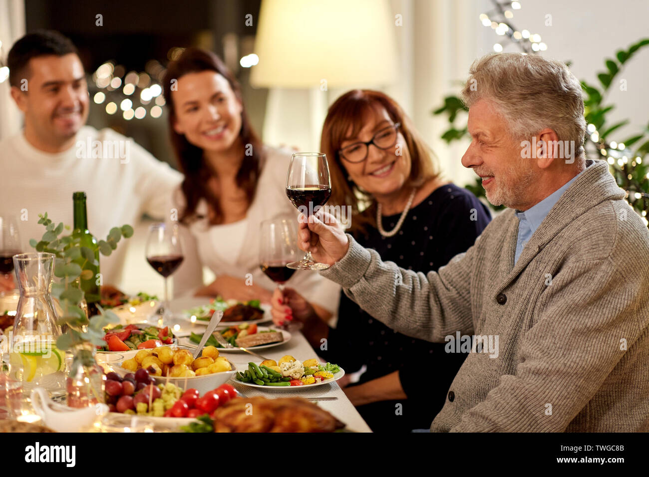 happy family having dinner party at home Stock Photo - Alamy