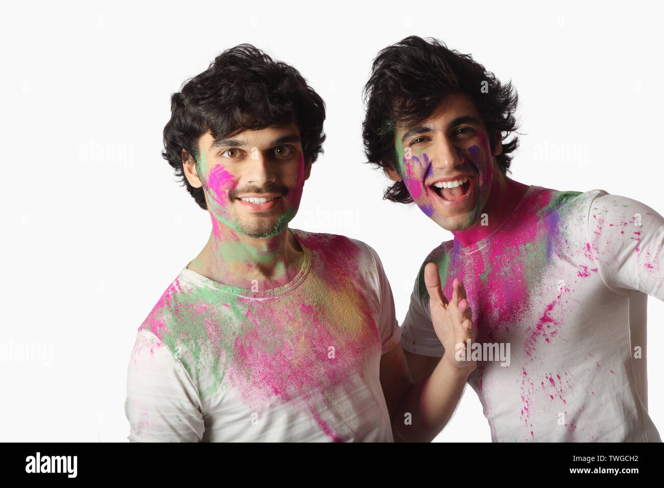 Two friends celebrating holi festival Stock Photo - Alamy