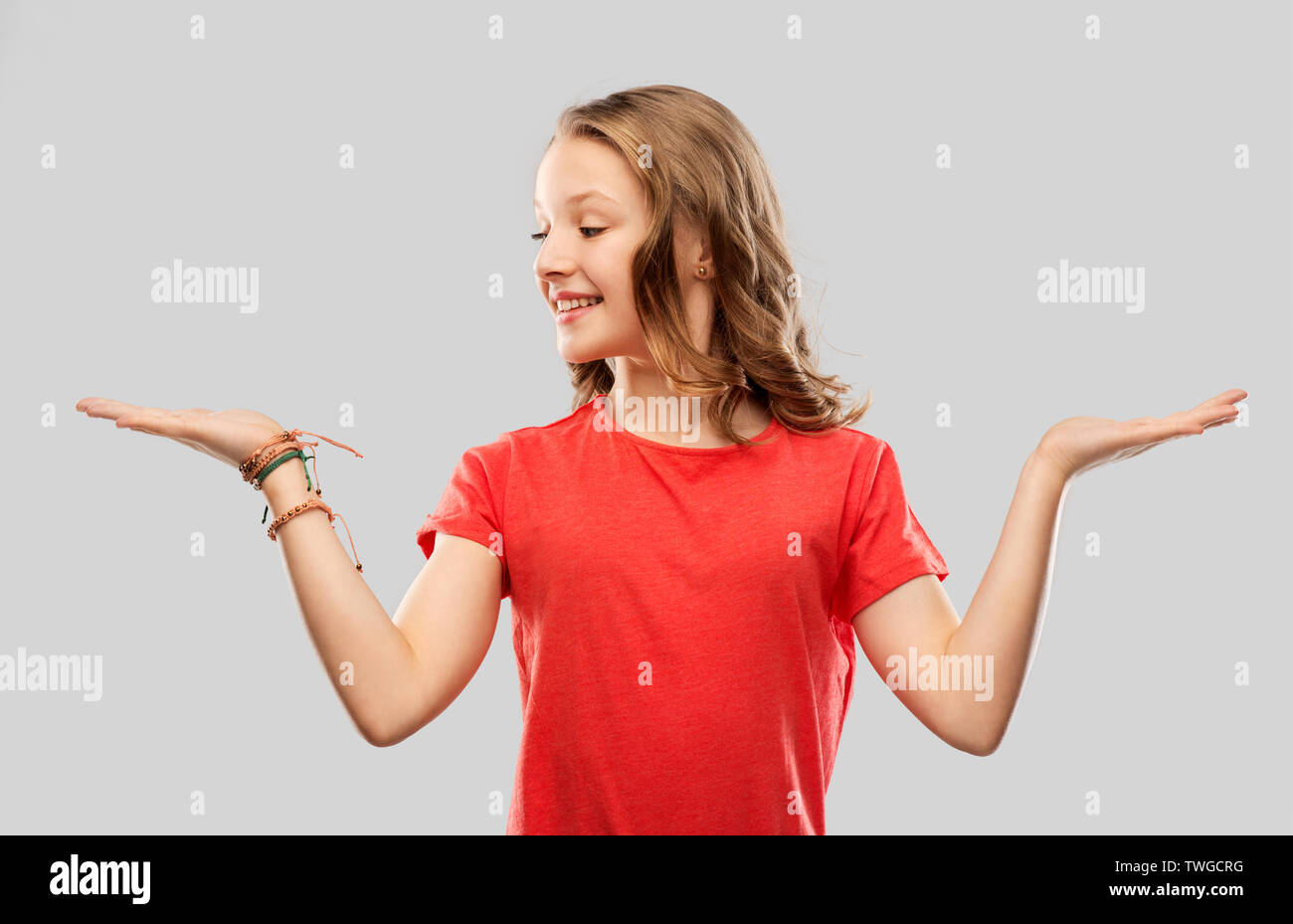 smiling teenage girl holding empty hand Stock Photo - Alamy
