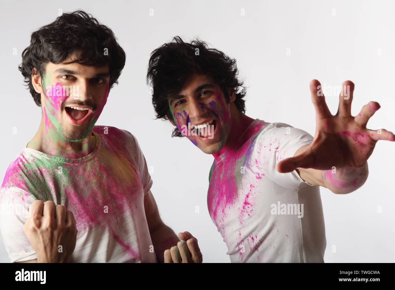 Two friends celebrating holi festival Stock Photo - Alamy