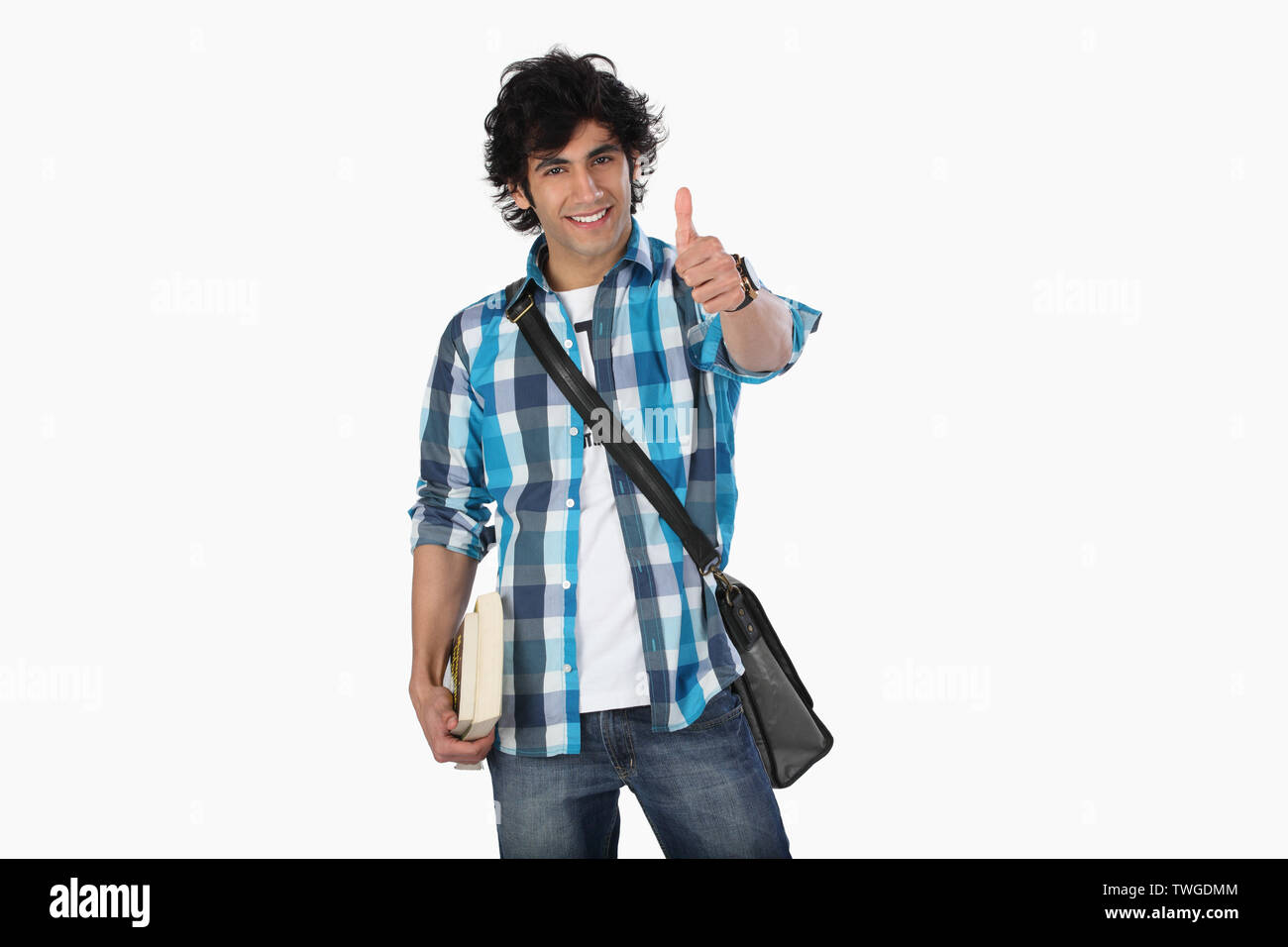 College student showing thumbs up sign and smiling Stock Photo - Alamy