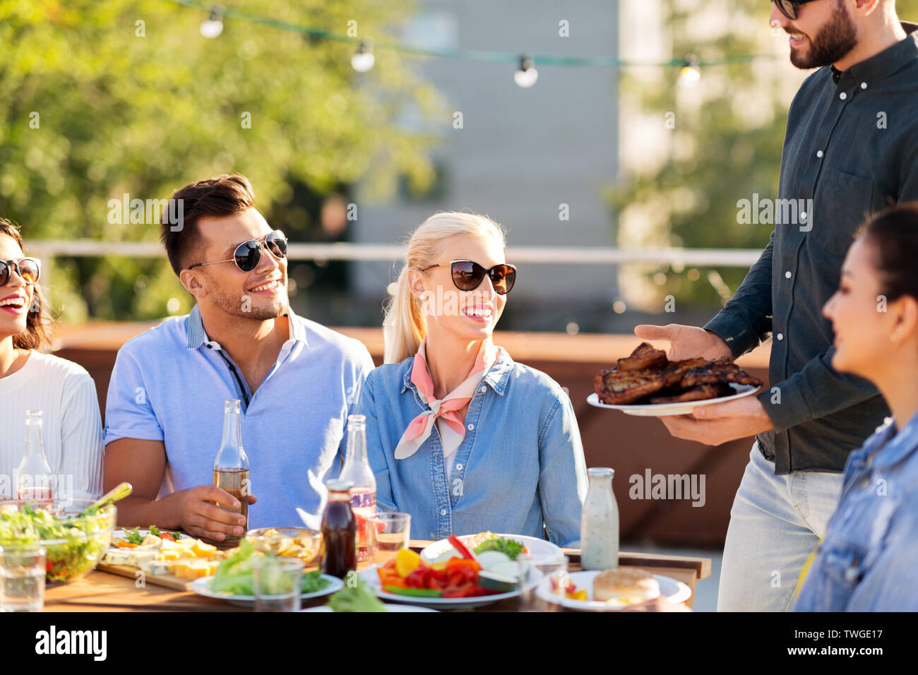 Woman host summer party hi-res stock photography and images - Alamy