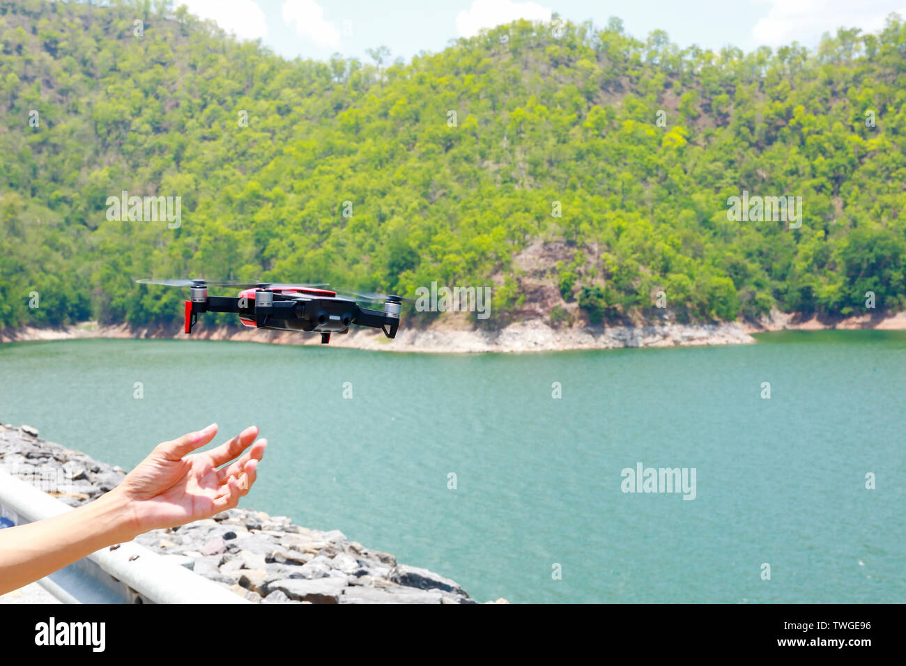 drone with the professional camera takes pictures of the reservoir in ...
