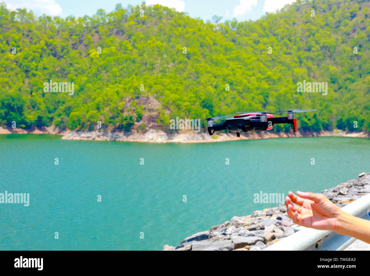 drone with the professional camera takes pictures of the reservoir in ...
