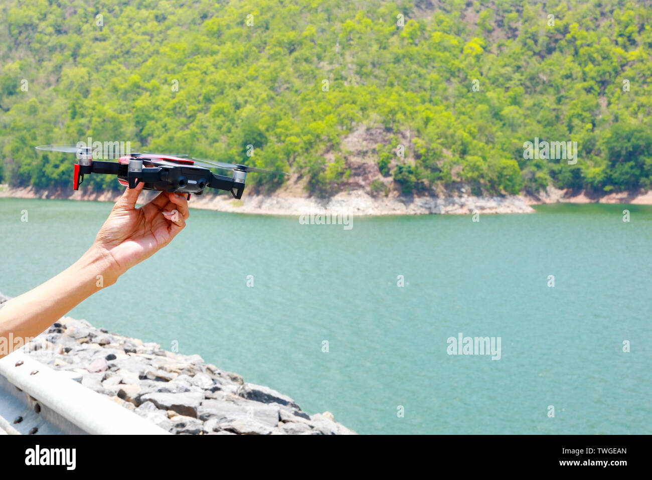 drone with the professional camera takes pictures of the reservoir in ...