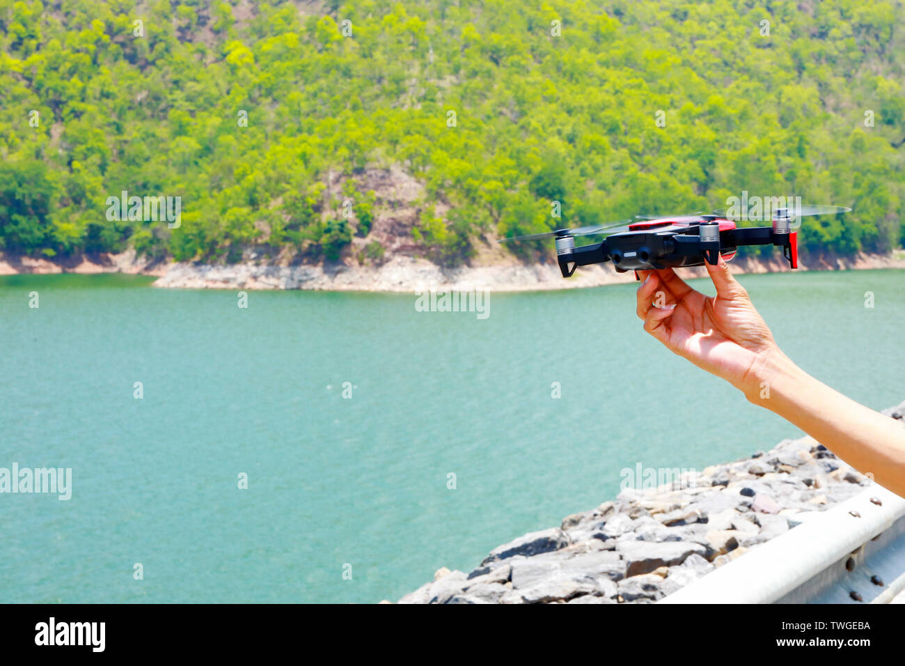 drone with the professional camera takes pictures of the reservoir in ...