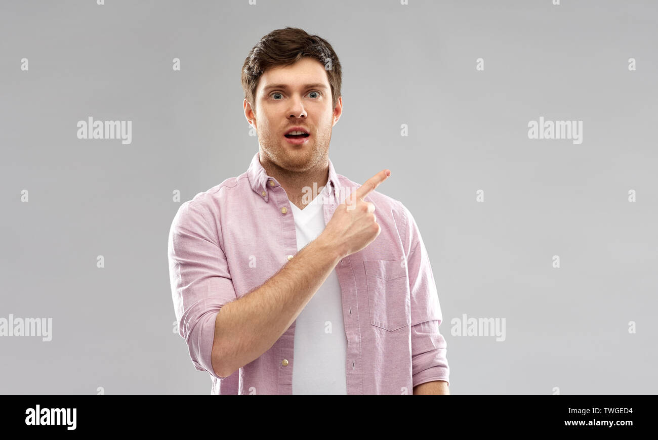 shocked young man showing something Stock Photo - Alamy